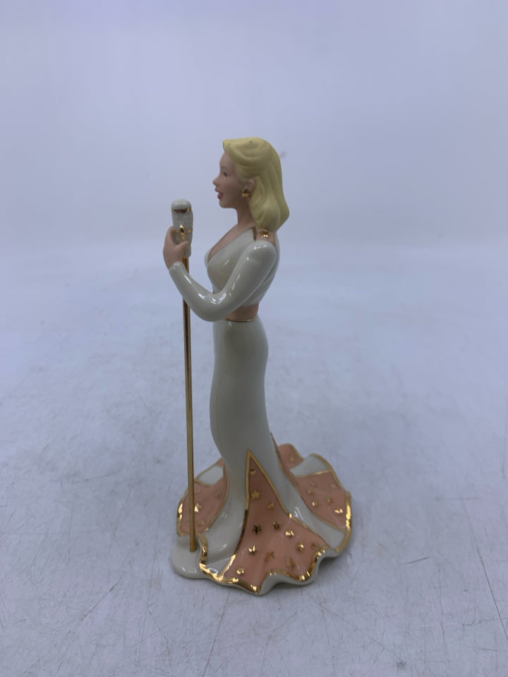 BLONDE WOMAN W/ MICROPHONE "A LONG WAY FROM HOME".